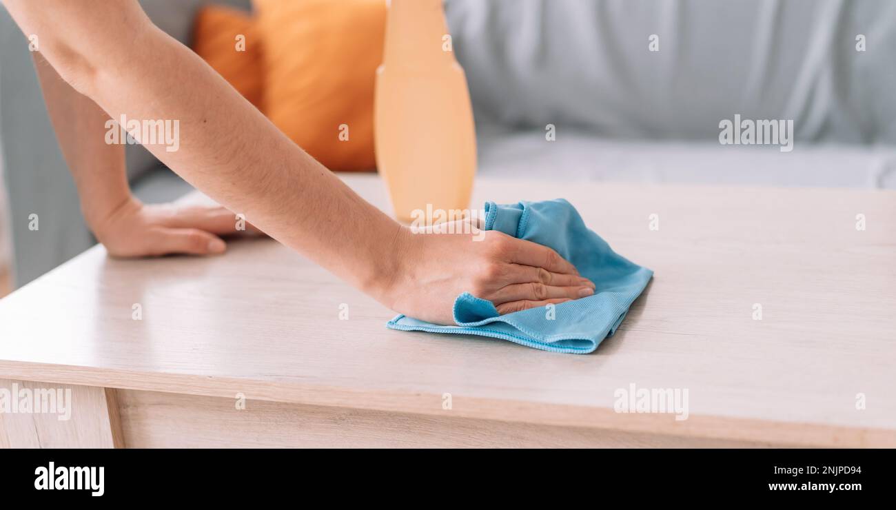 Lady cleaning with a rag the table with detergent Stock Photo - Alamy