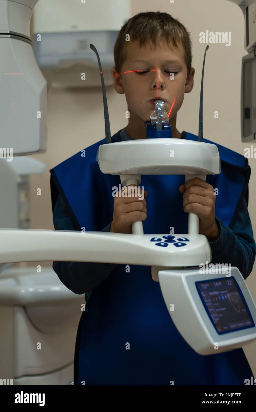 Jaw computed tomography, check up teeth in dental clinic. Little boy on ...