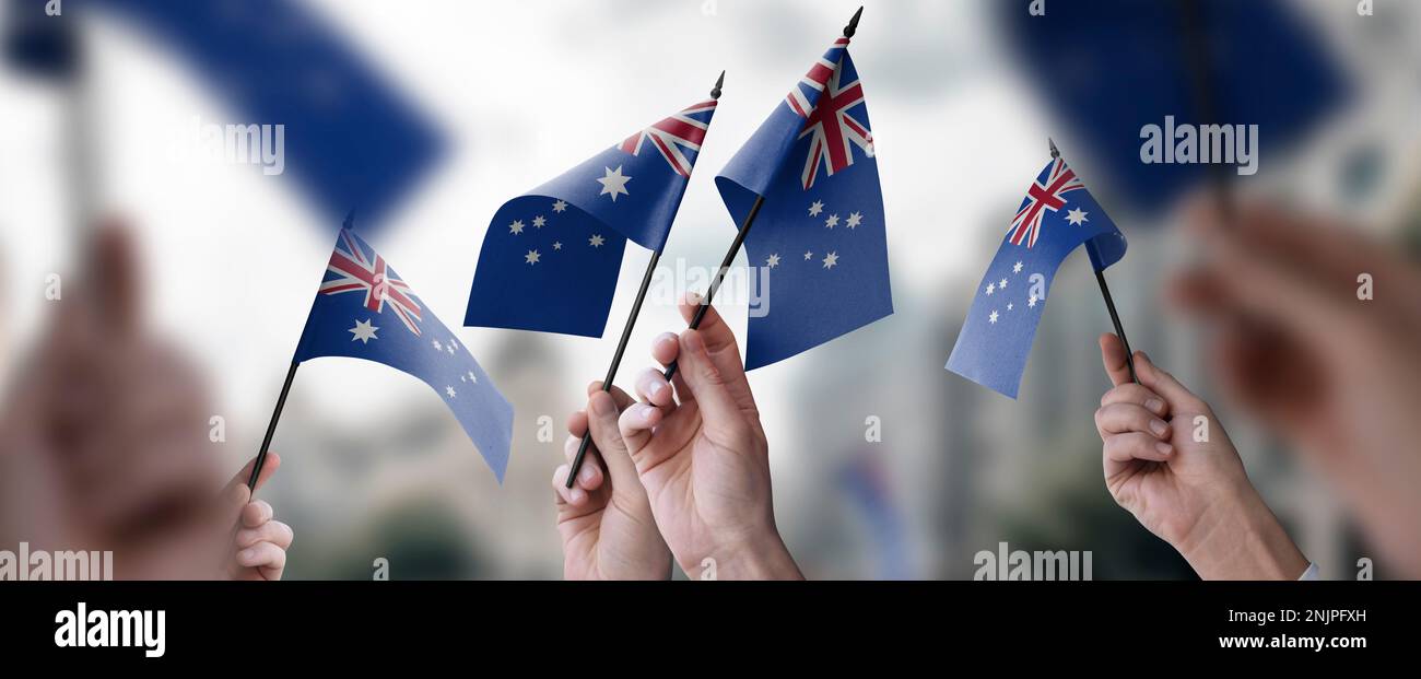 A group of people holding small flags of the Australia in their hands ...