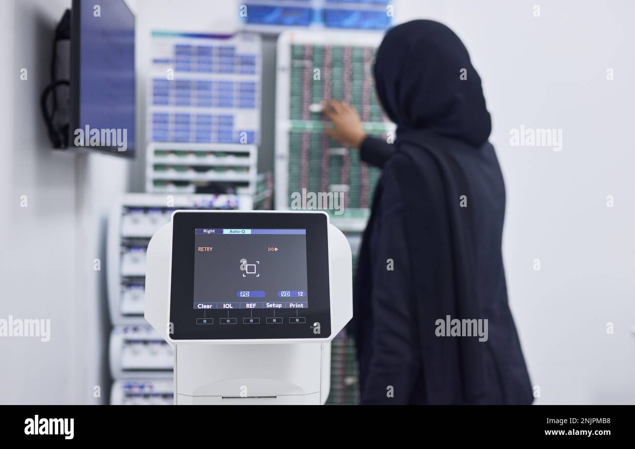 Optometry, screen for eye exam and Muslim optician with machine for ...