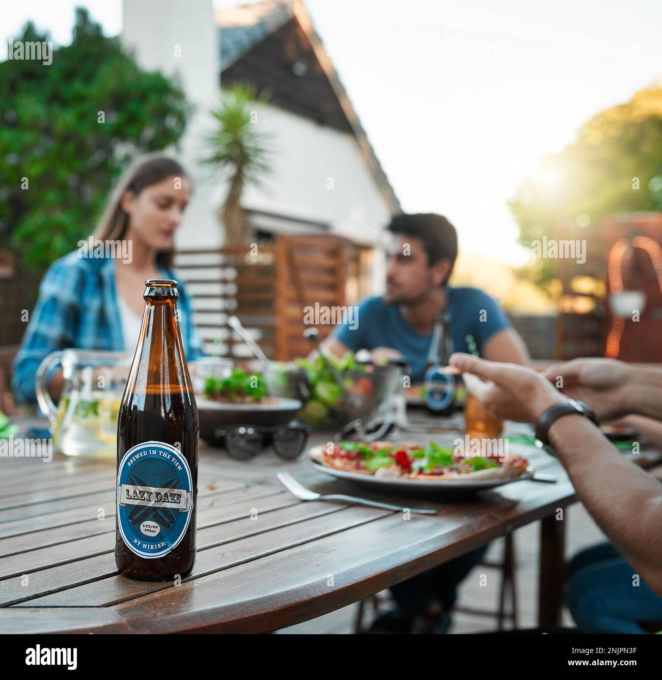 Its a gathering of friends. a young group of friends enjoying a meal ...