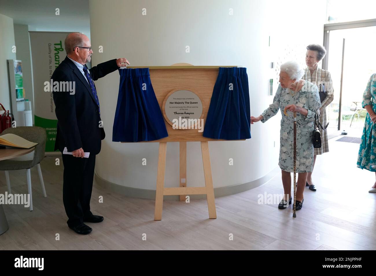 Queen Elizabeth II unveils a plaque during a visit to officially open ...