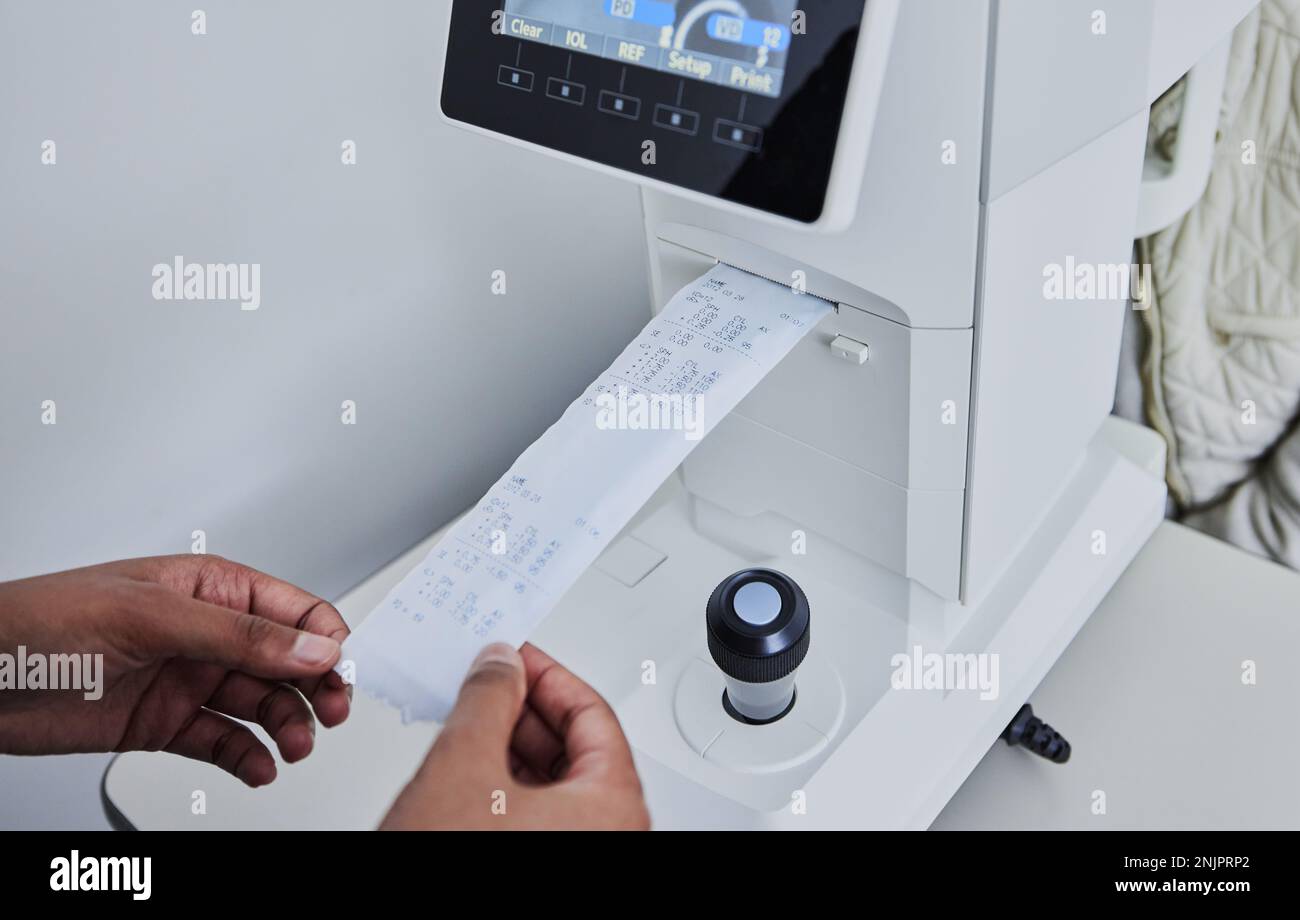 Ophthalmology, healthcare and printing with hands of person and machine ...