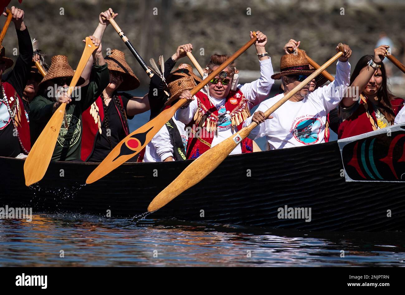 Members of the Squamish Nation paddle a traditional canoe on False ...