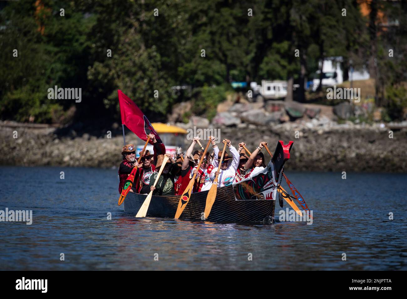 Members of the Squamish Nation paddle a traditional canoe on False ...