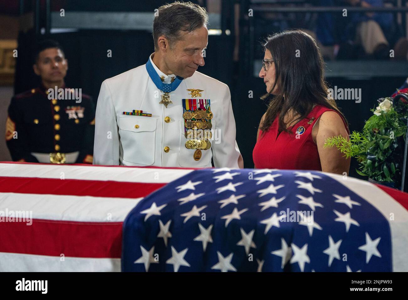 Medal of Honor recipient Britt Slabinski pays his respects as the flag ...