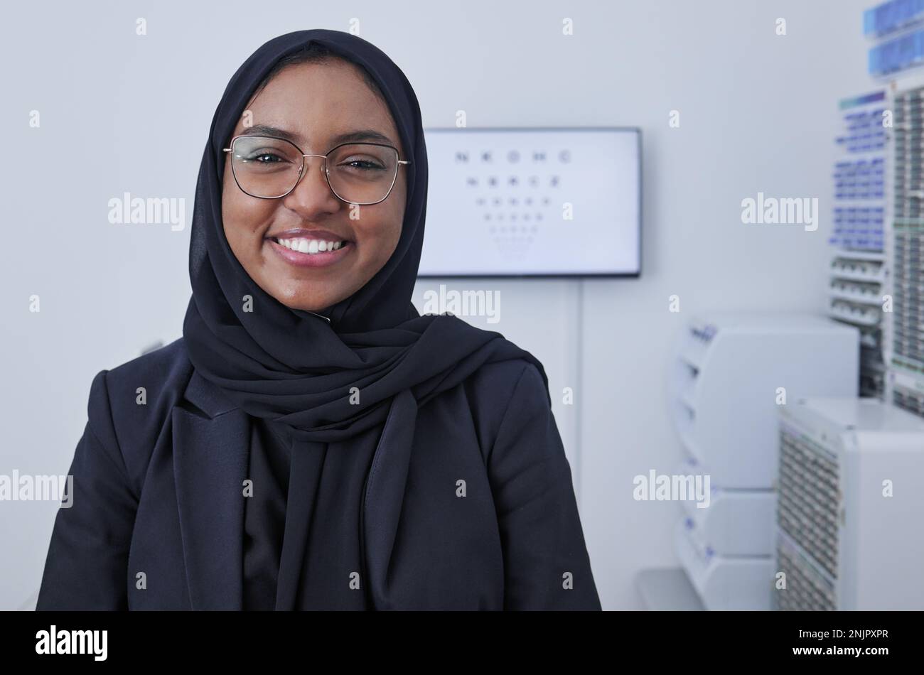 Hijab, happy muslim woman and optometrist portrait in a doctor office ...
