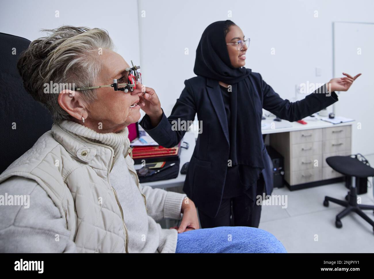 Eye exam, frame and woman reading with optometrist in clinic for vision ...