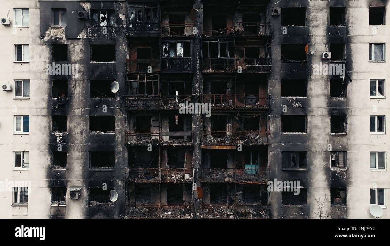 A burnt-out high-rise in the war zone. Damage to a residential building ...