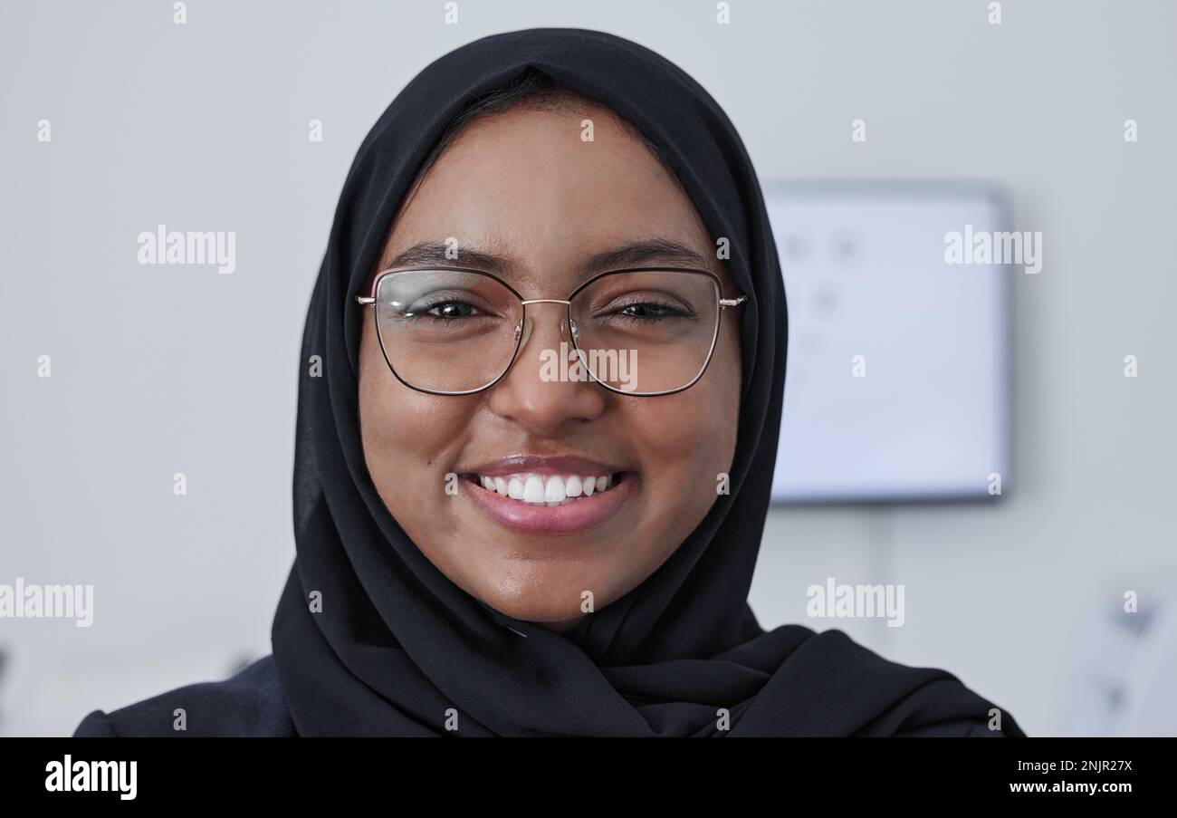 Hijab, muslim woman smile and portrait in a consulting doctor office ...