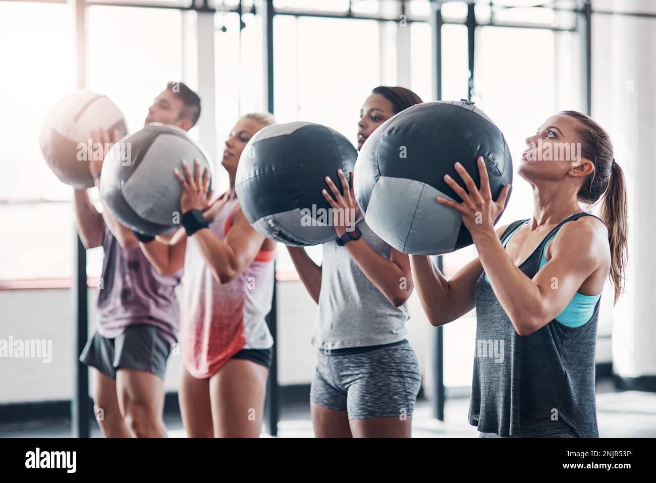 Mix up your routine for a better workout. a fitness group working out ...