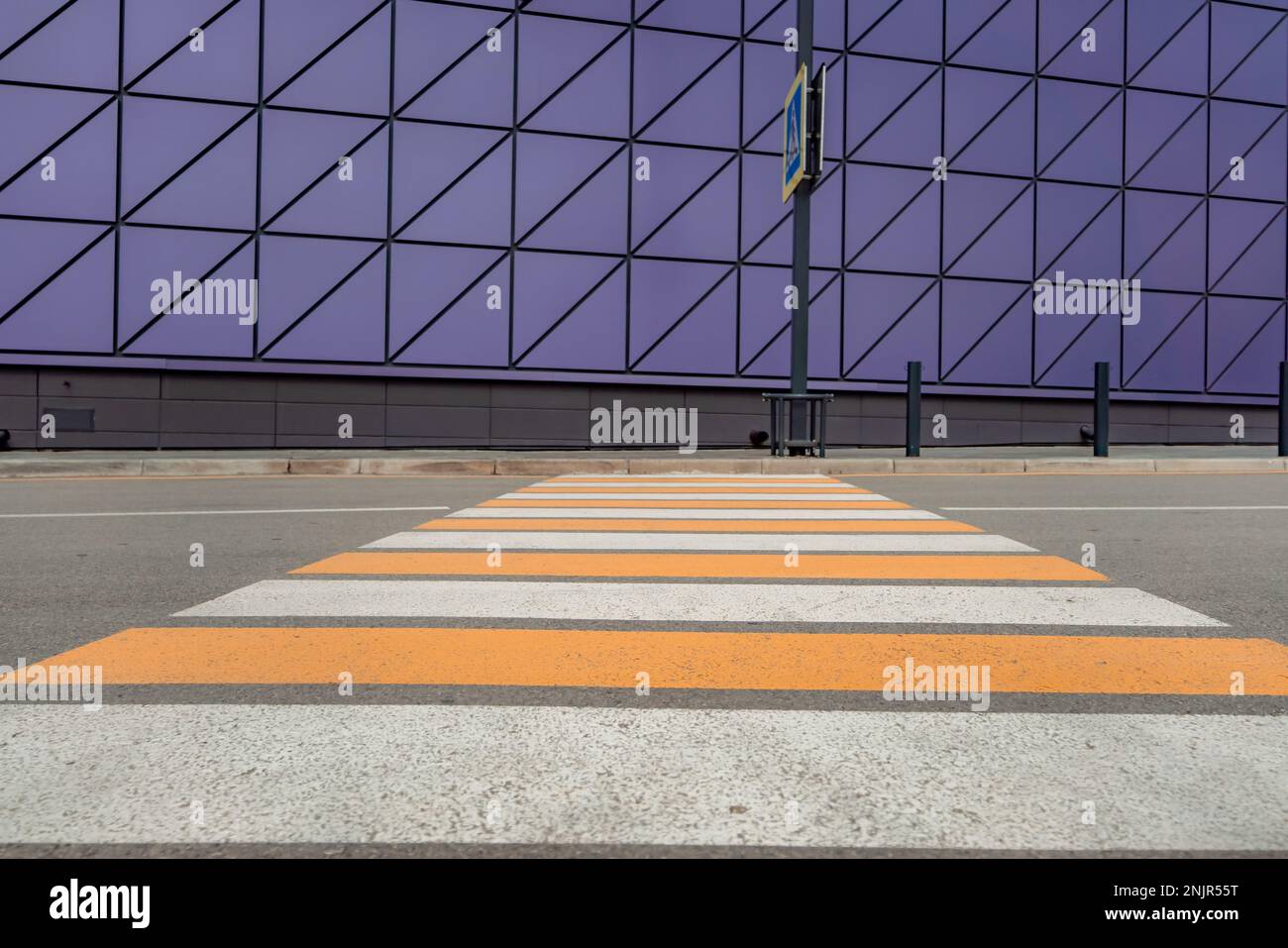 Pedestrian crosswalk on a renovated paved road, to the beginning of the ...