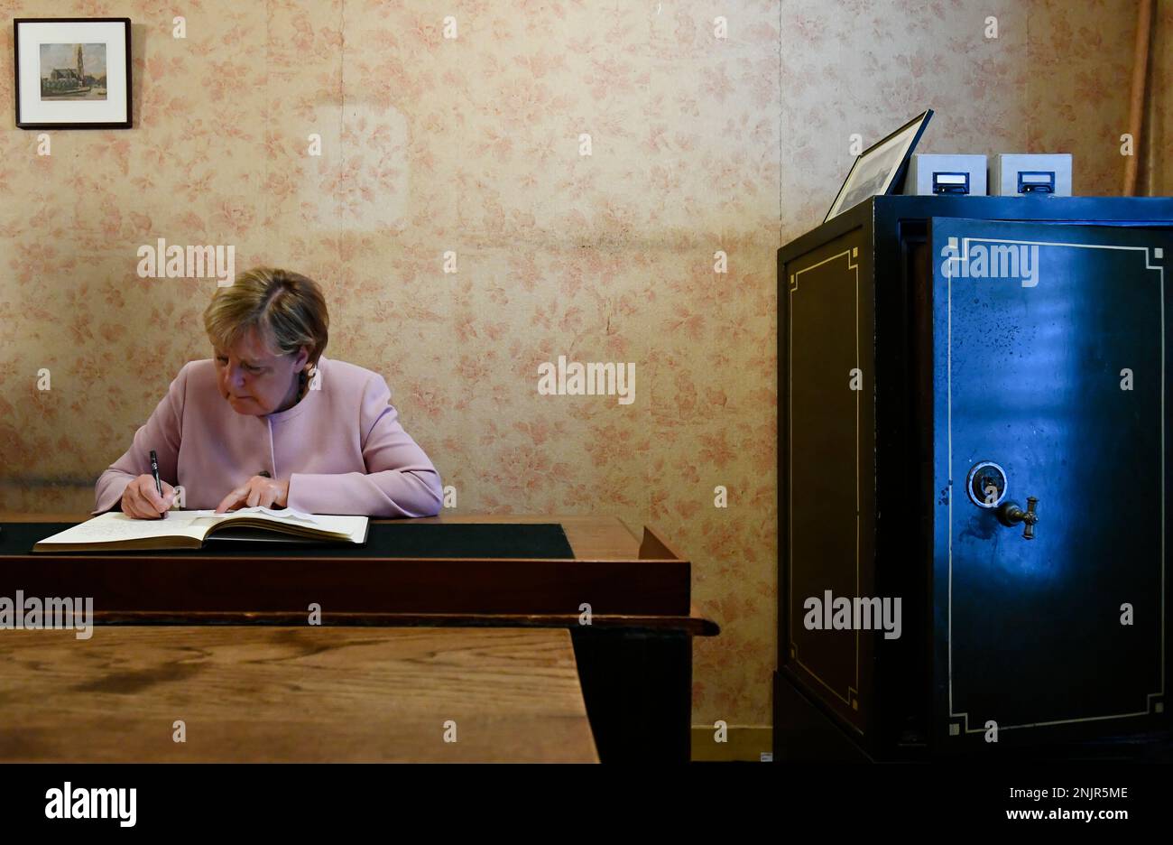 Former German Chancellor Angela Merkel signs the guest book on Otto ...