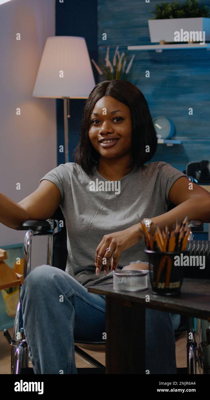 Portrait of black girl with disability creating drawing in workshop ...