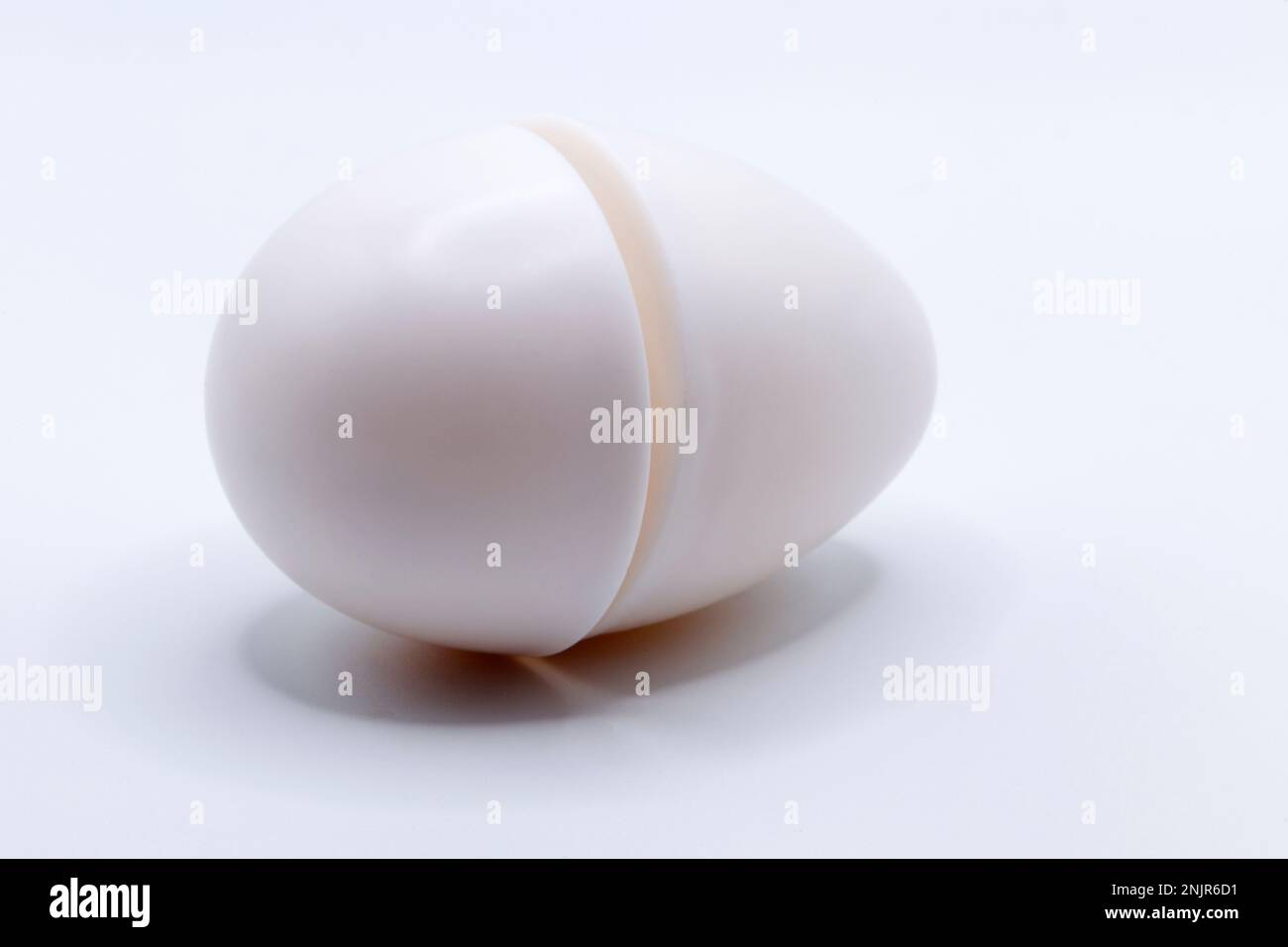 a toy egg that can be split in half on a white background Stock Photo ...