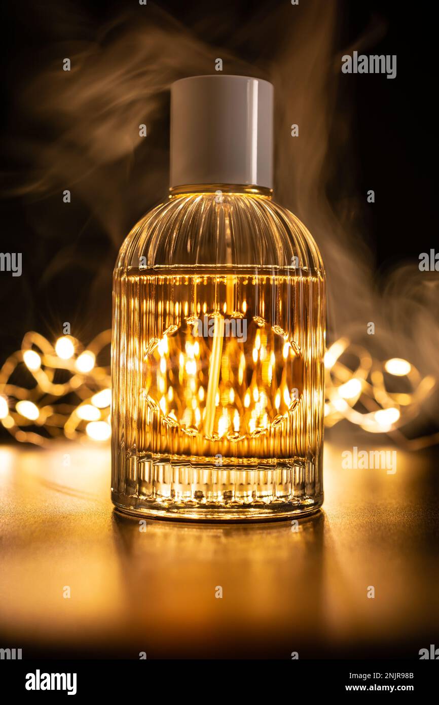 Mock-up of cosmetic product. Glass bottle of perfume with smoke on ...