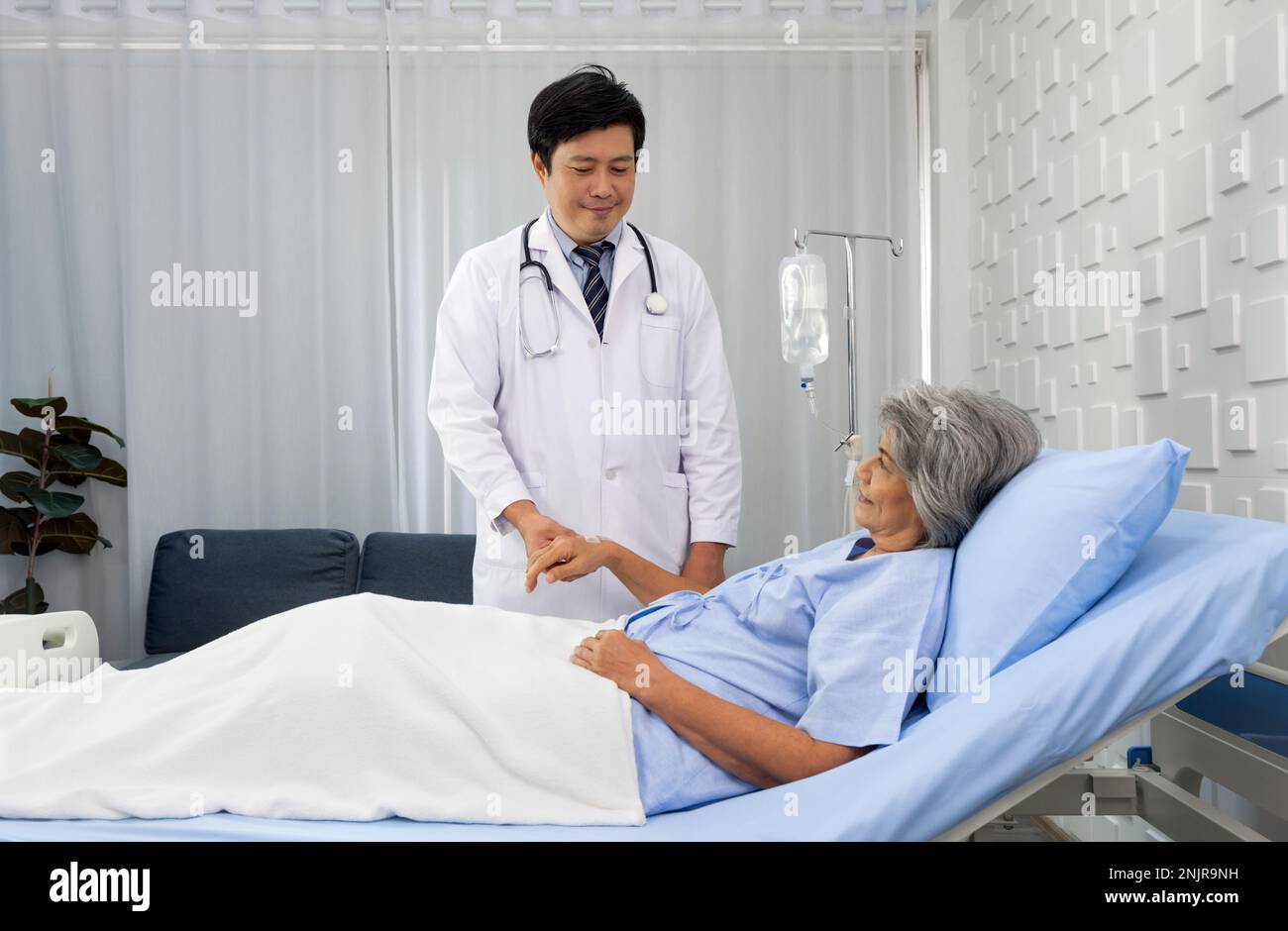 Senior female patient and doctor. Asian doctor with stethoscope check ...