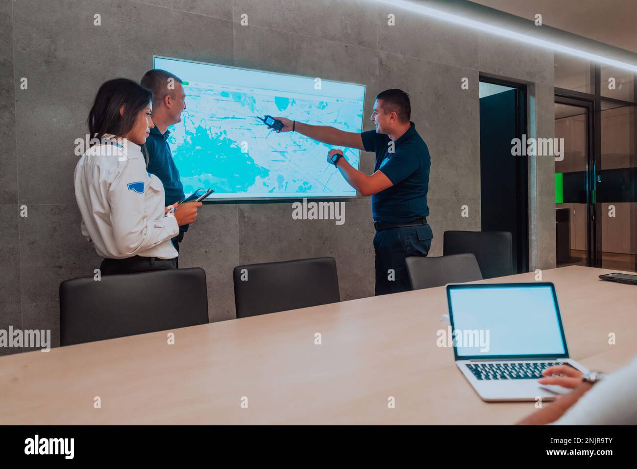 Group of security operators working in a data system control room ...
