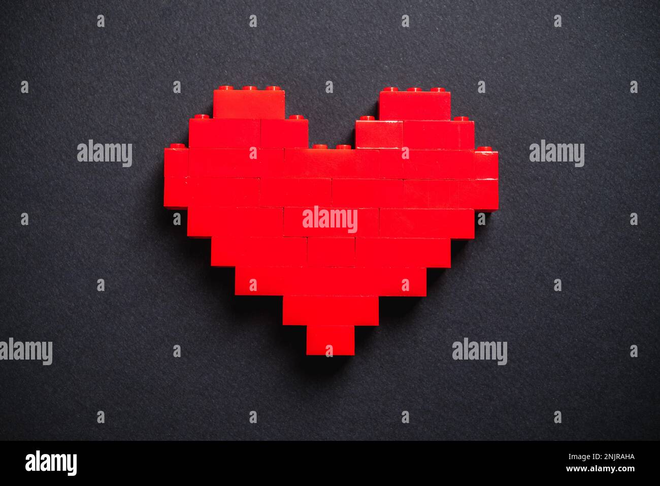 Red heart made of plastic bricks on a dark gray background Stock Photo ...