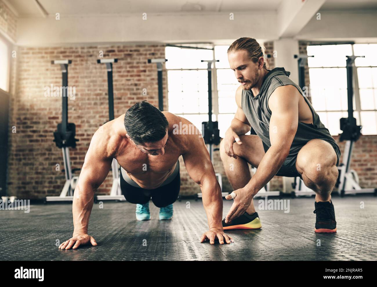 Keep counting. two fit and determined young men doing pushups one by ...