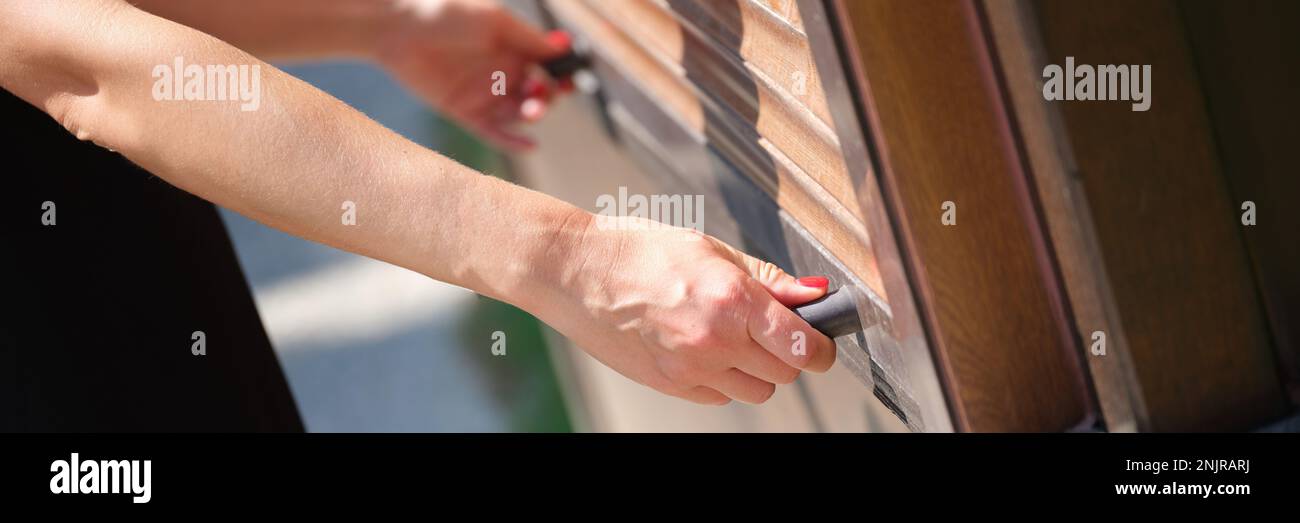 Woman opening shutters hi-res stock photography and images - Alamy
