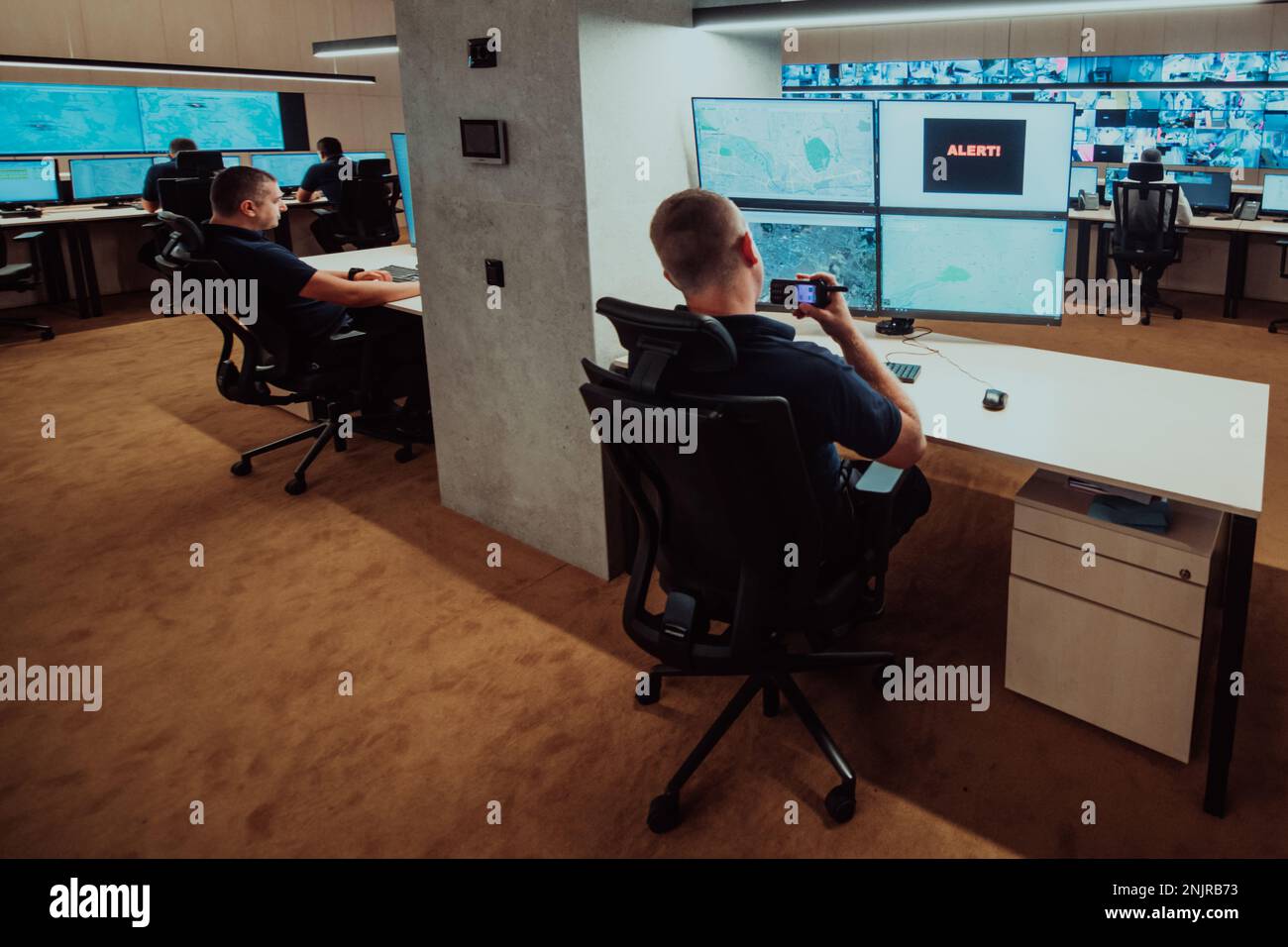 Group of Security data center operators working in a CCTV monitoring ...