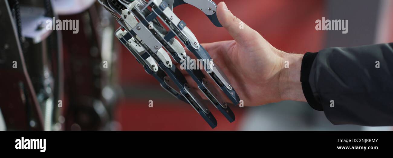 Robot extends its hand to woman for handshake. Artificial intelligence ...