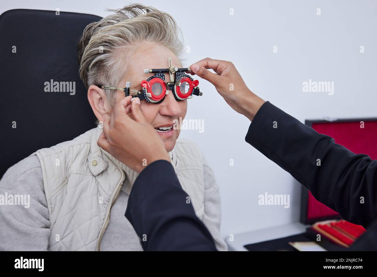 Eye exam, frame and senior woman with optometrist in clinic for vision ...