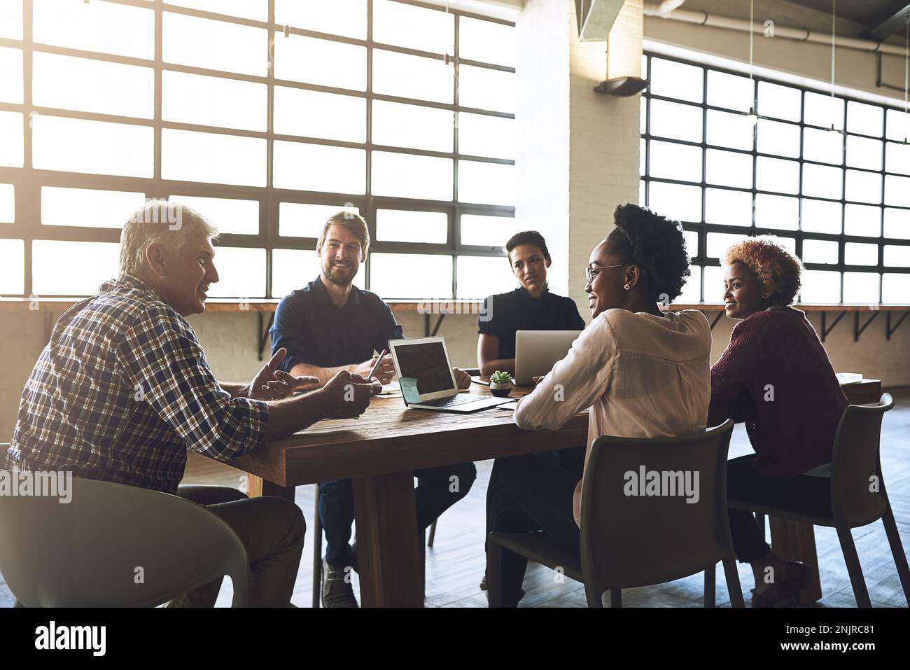 Great teams discuss ideas. a group of colleagues having an office ...