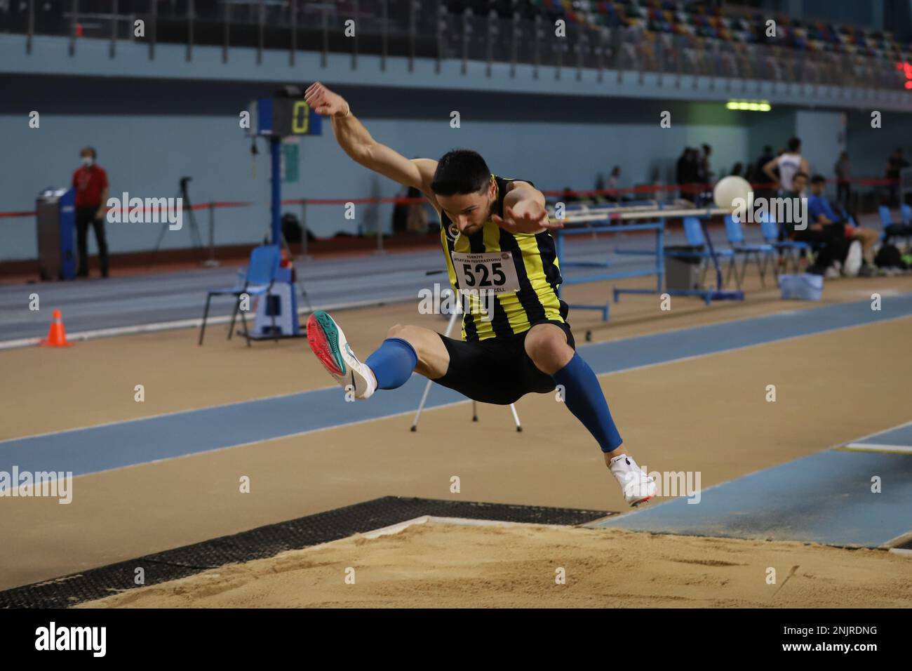 ISTANBUL, TURKEY - FEBRUARY 26, 2022: Undefined athlete long jumping ...