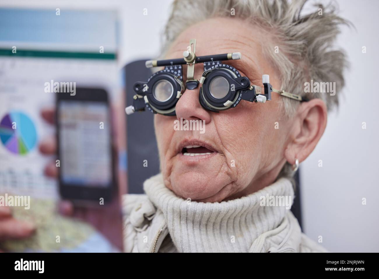 Eye exam, reading and senior woman with frame in clinic for vision ...