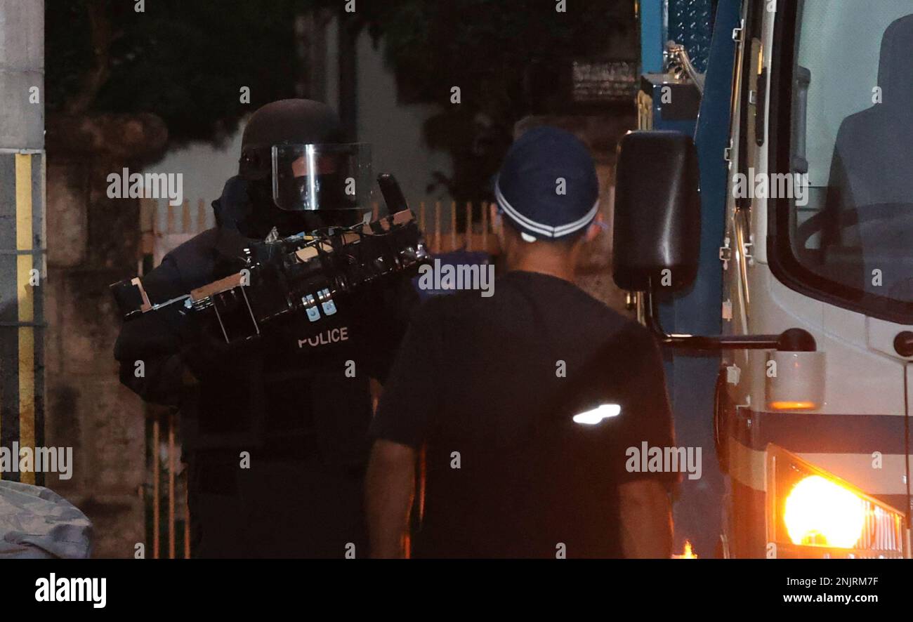 A police officer carries as suspected homemade gun from Tetsuya ...