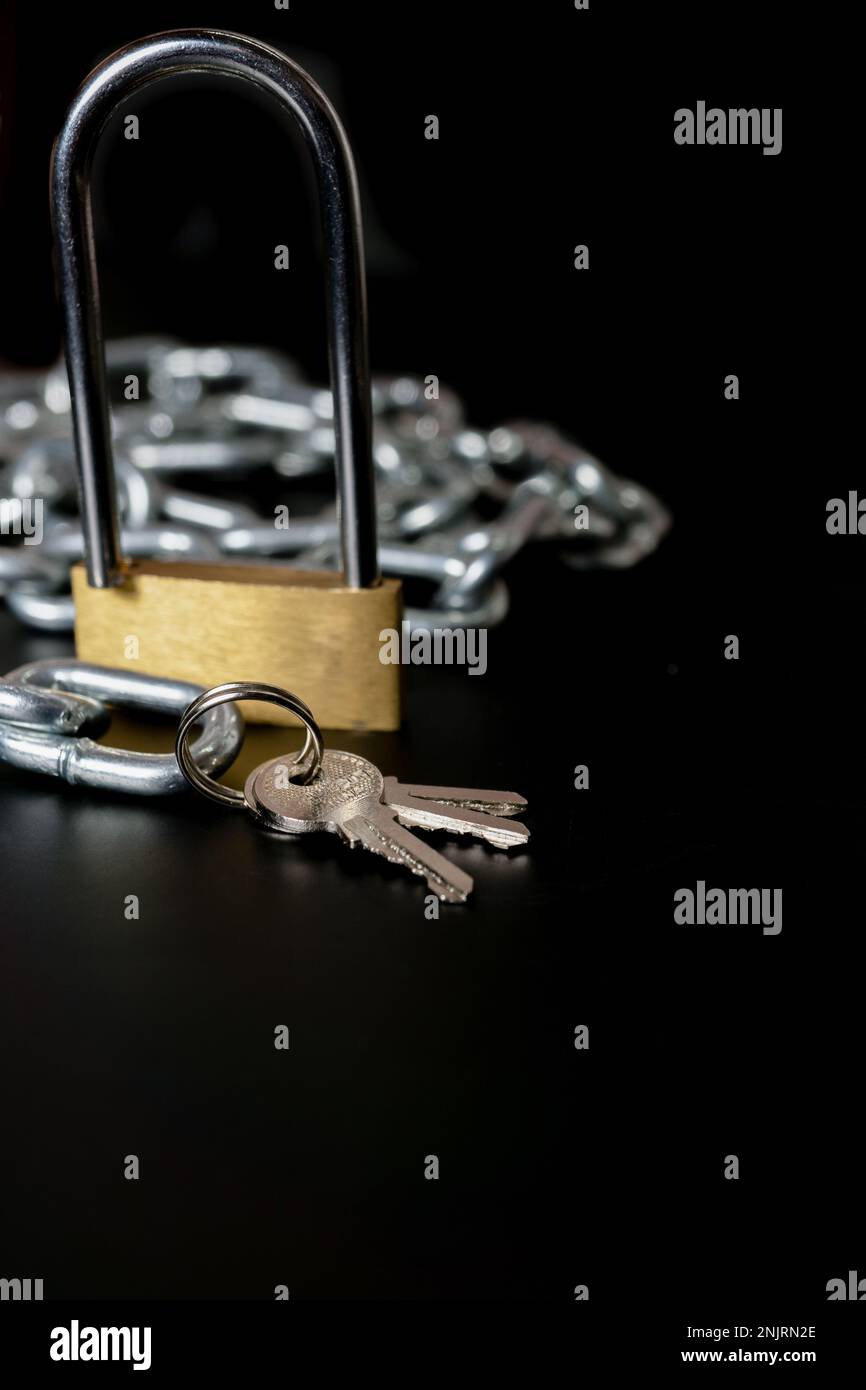 padlock with key and chains in the background isolated on a black ...