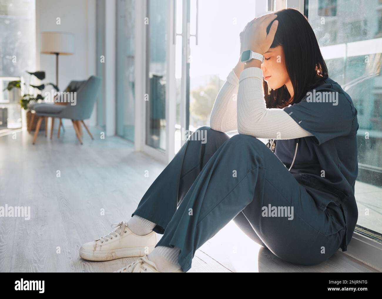 Nurse, depression and woman with stress in hospital after loss, grief ...