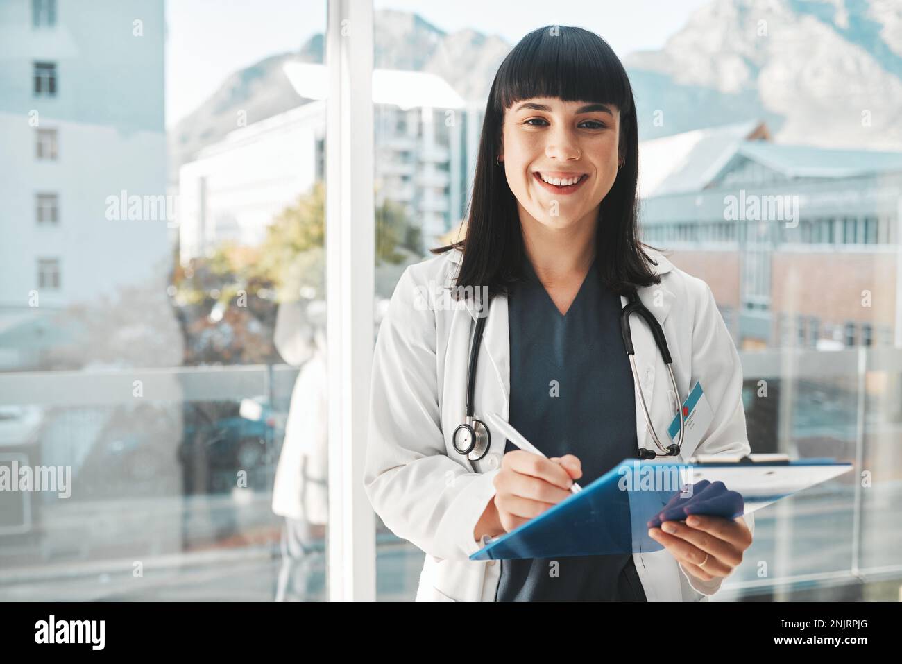 Portrait busy doctor standing holding hi-res stock photography and ...