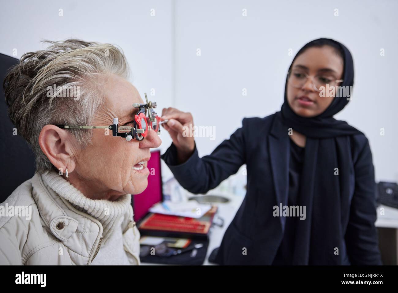 Eye exam, frame and senior woman with optometrist in clinic for vision ...