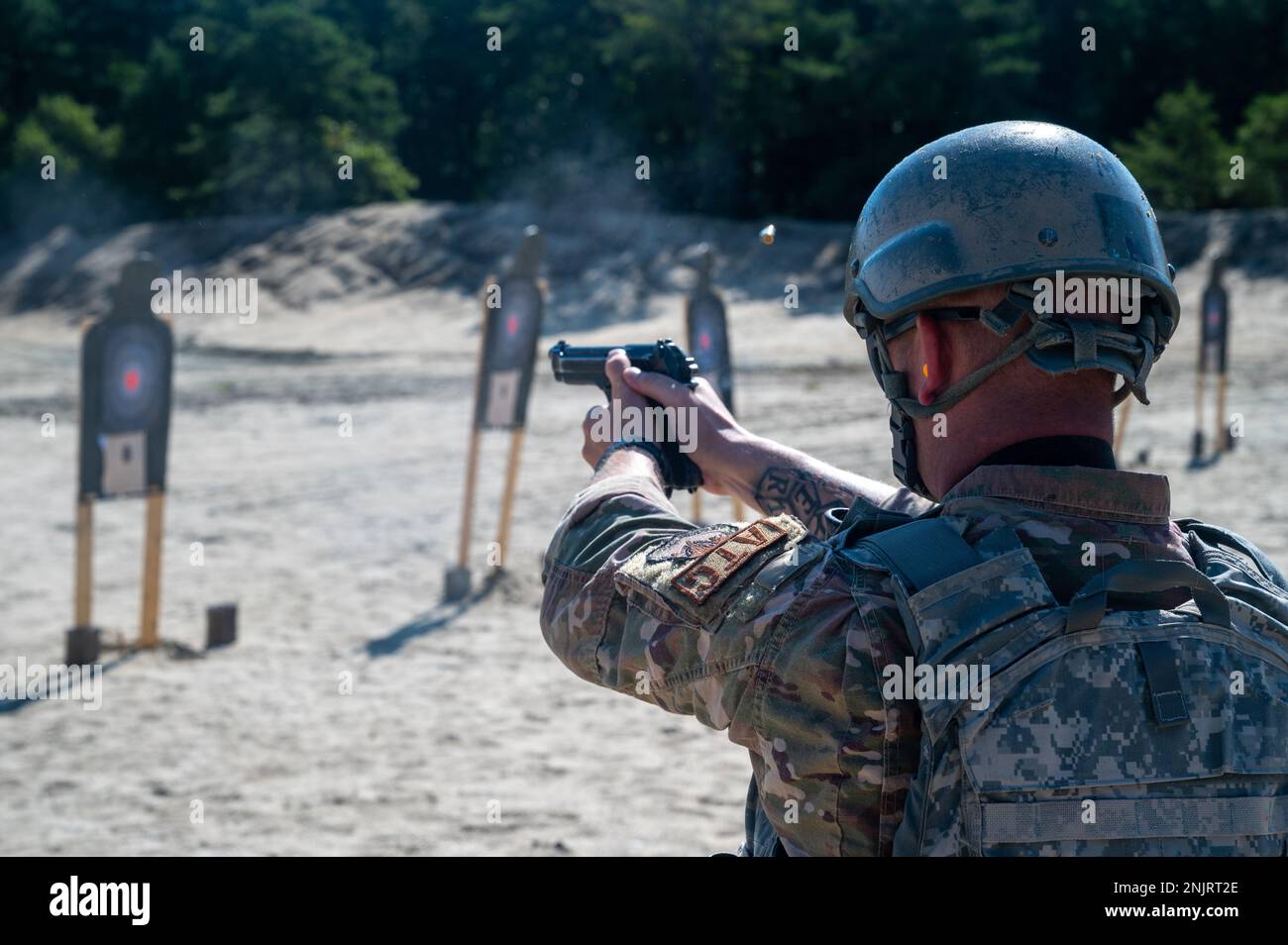A U.S. Air Force Air Traffic Controller fires his pistol during ...