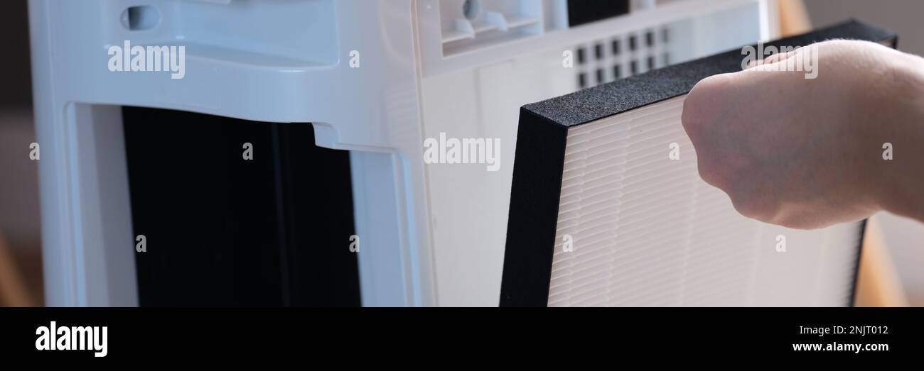 Replacing the filter in air conditioner and outdoor air purifier Stock ...