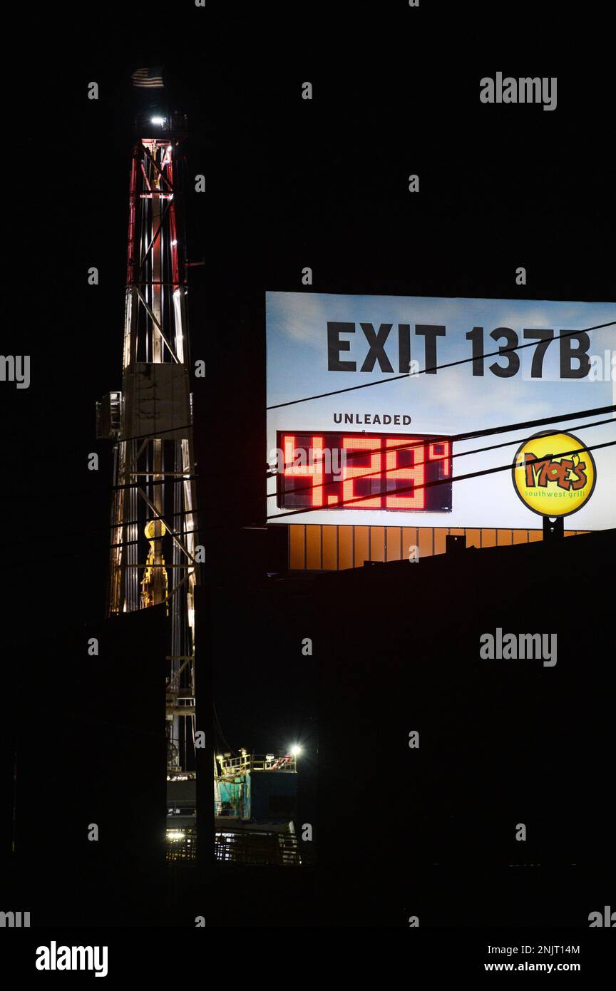A billboard displays the current price of a gallon of unleaded gasoline ...