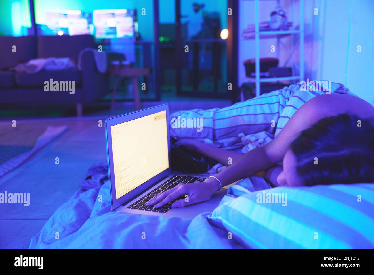 Night, woman and laptop while sleeping in home bed with light from ...