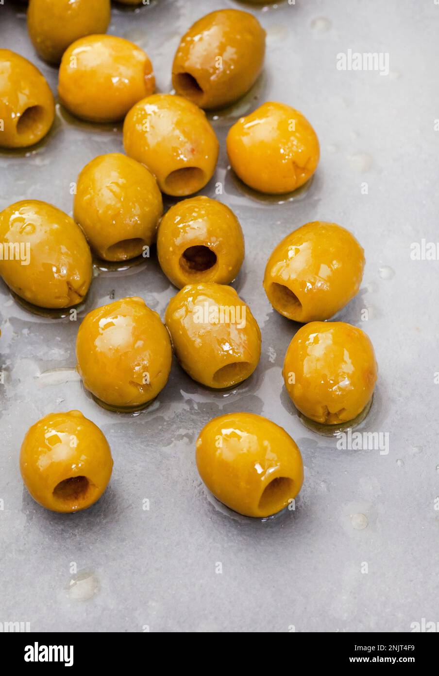 pitted green olives with oil on mottled gray with copy space Stock ...