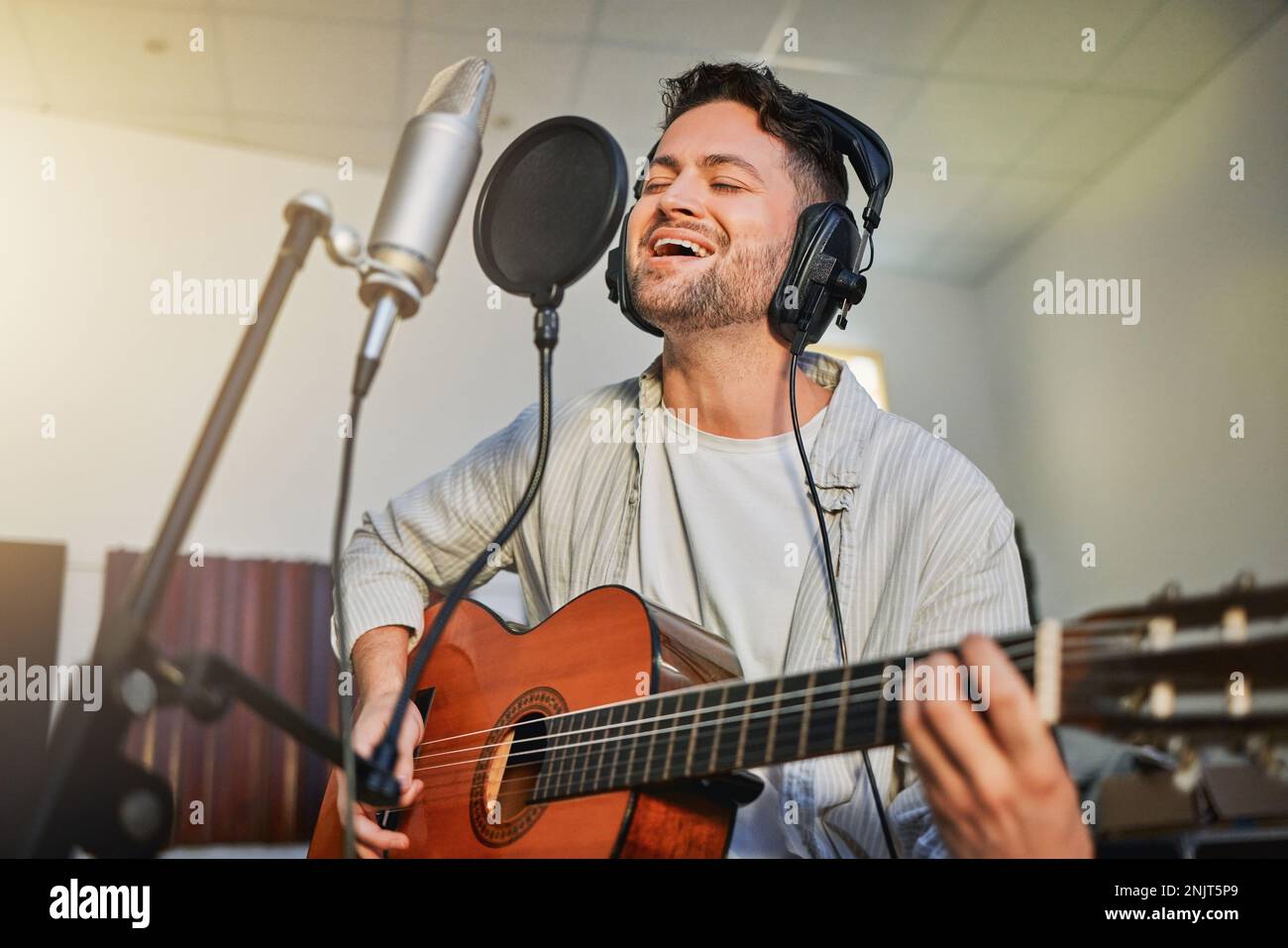 Guitar, microphone and singing in studio for album recording, theatre ...