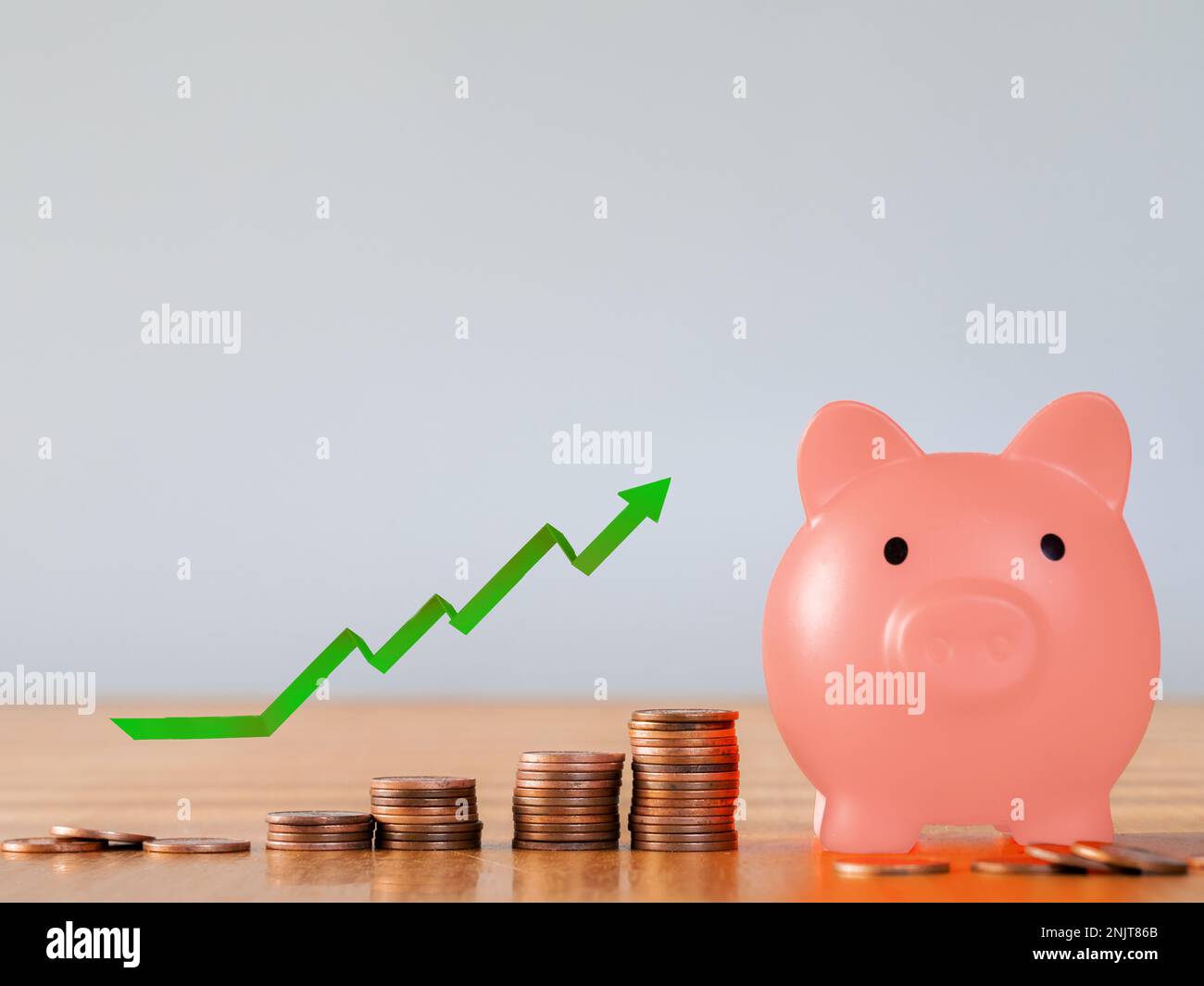 Saving money concept. piggy bank, stack of silver coins with growth ...