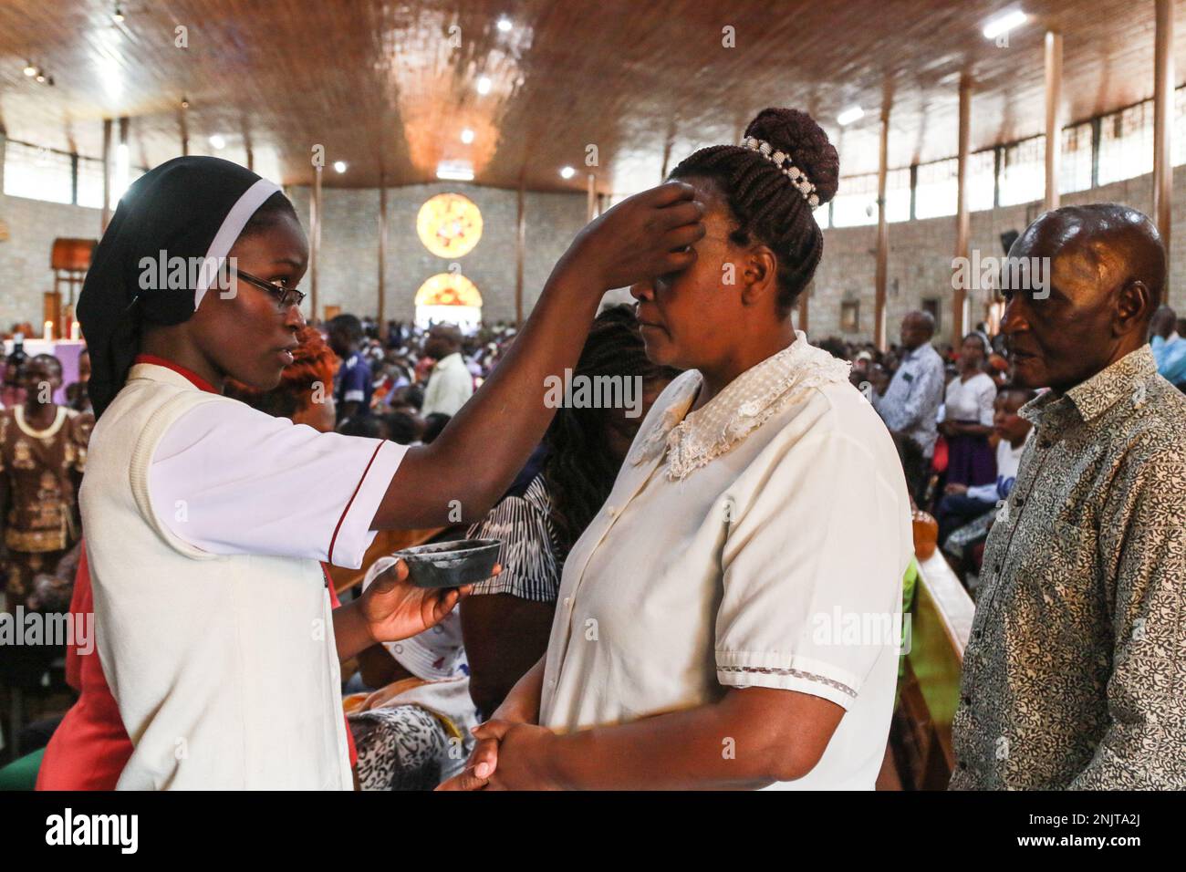 Nakuru, Kenya. 22nd Feb, 2023. A clergy smears a sign of the cross on ...