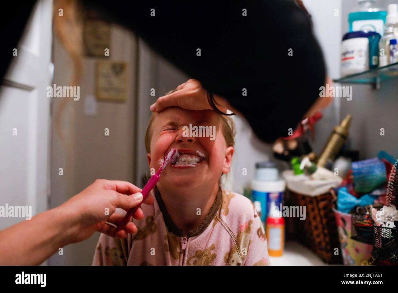 Maleah Varney, 5, makes silly faces while she gets her teeth brushed by ...