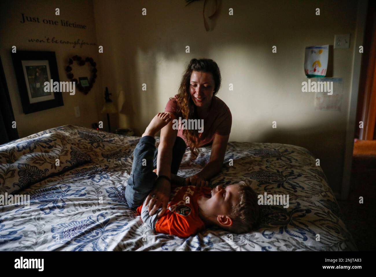 Jessica Varney tickles her son Nolan Varney, 4, as she gets him ready ...