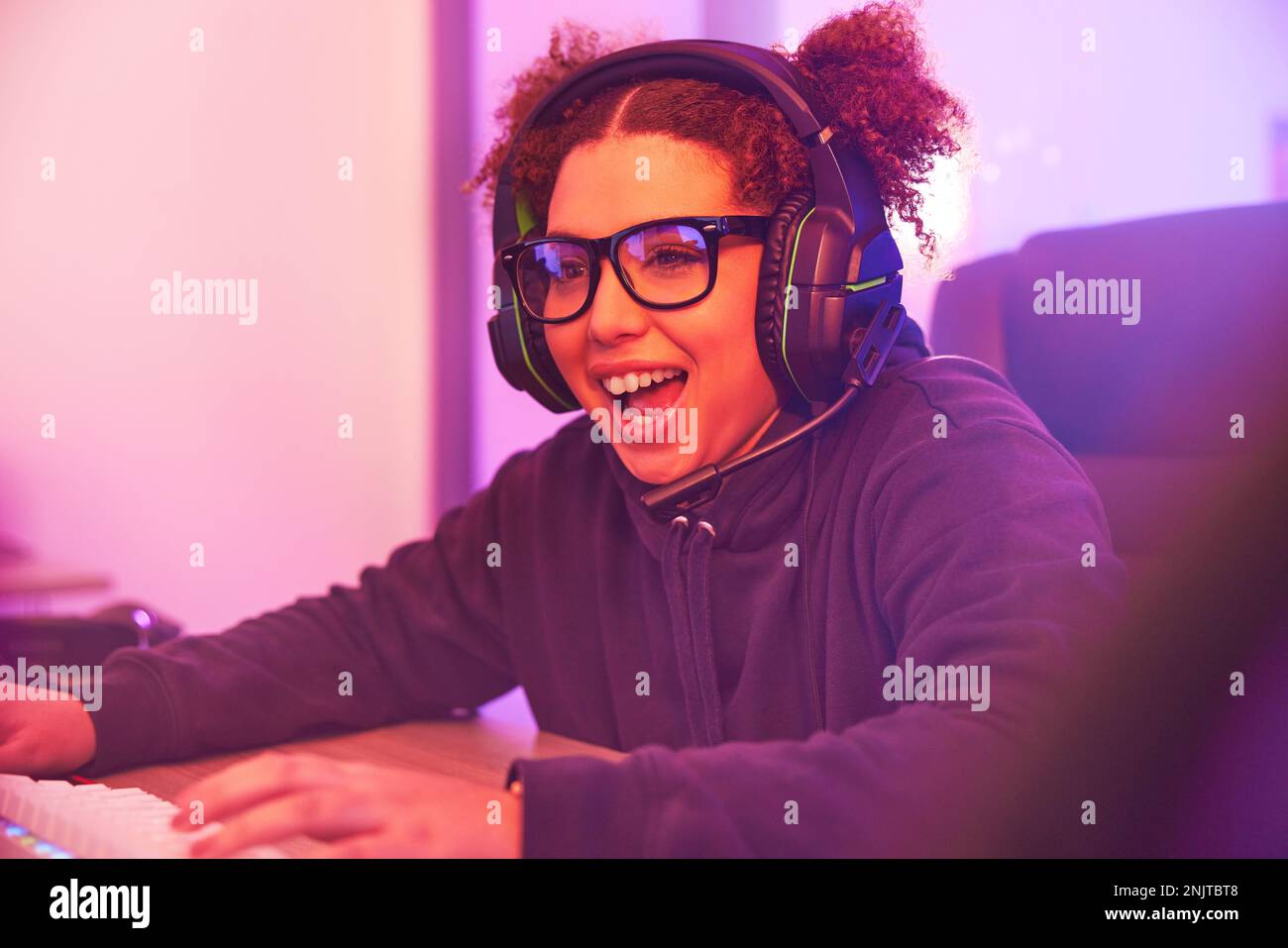 Happy, wow or woman gamer on computer with microphone playing games ...