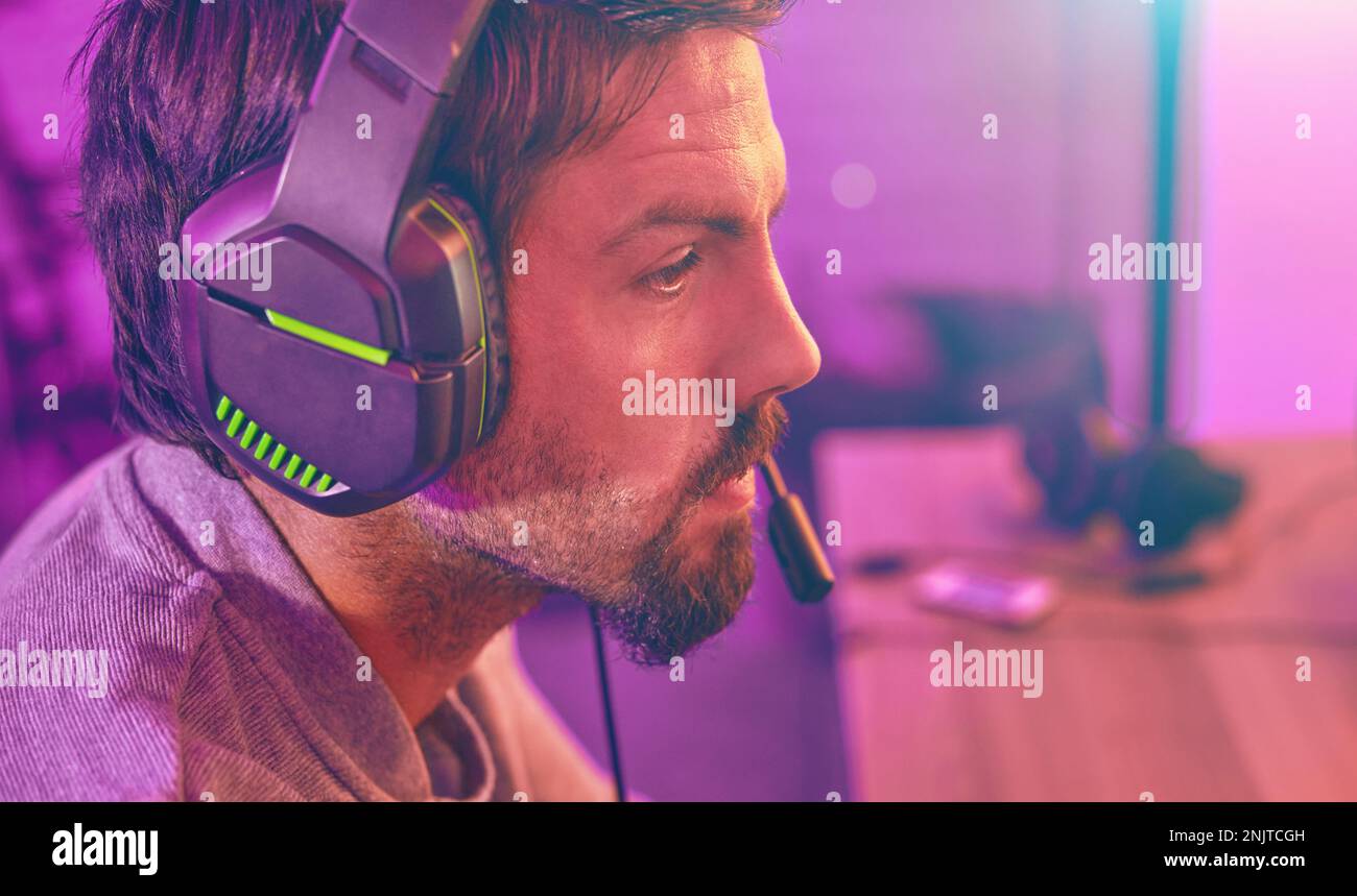 Serious face, gamer or man with headphone focus on online competition ...
