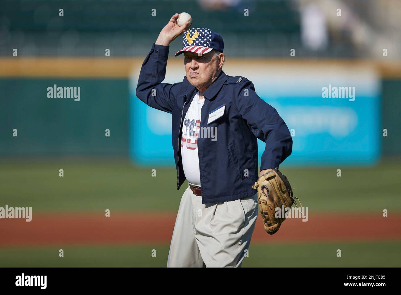 Colonel James Quincy Collins Jr. prepares to throw out the ceremonial ...