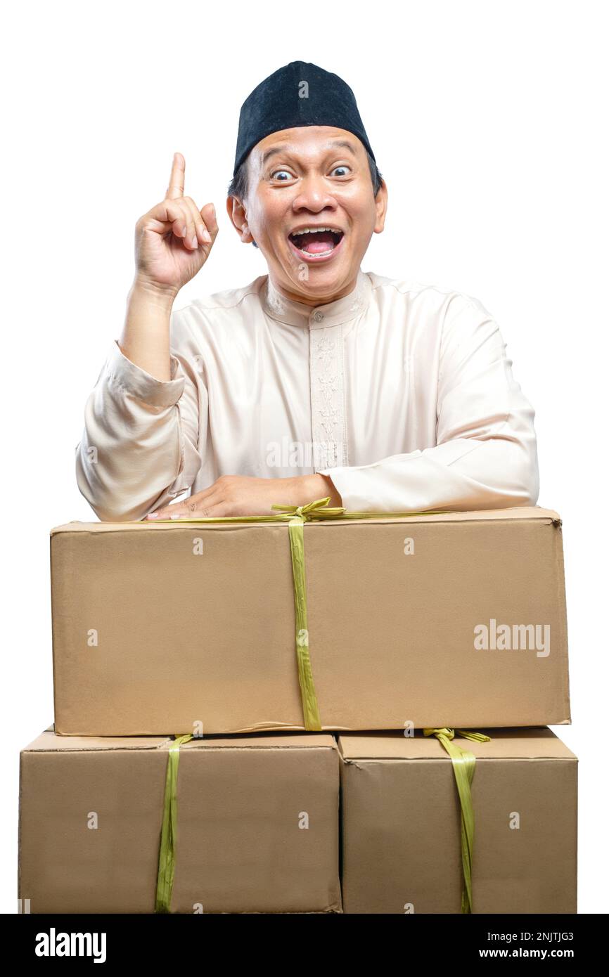 Asian Muslim man with a box thinking about mudik isolated over white ...